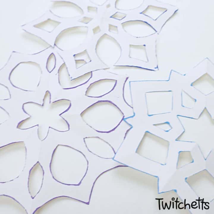 How to make a six-sided snowflake paper craft with inked edges.
